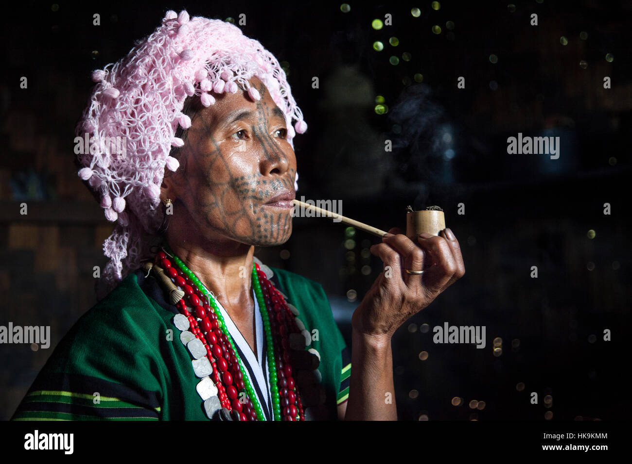 Chin region, Myanmar, November 11, 2014: muun tribe chin lady smoking a ...