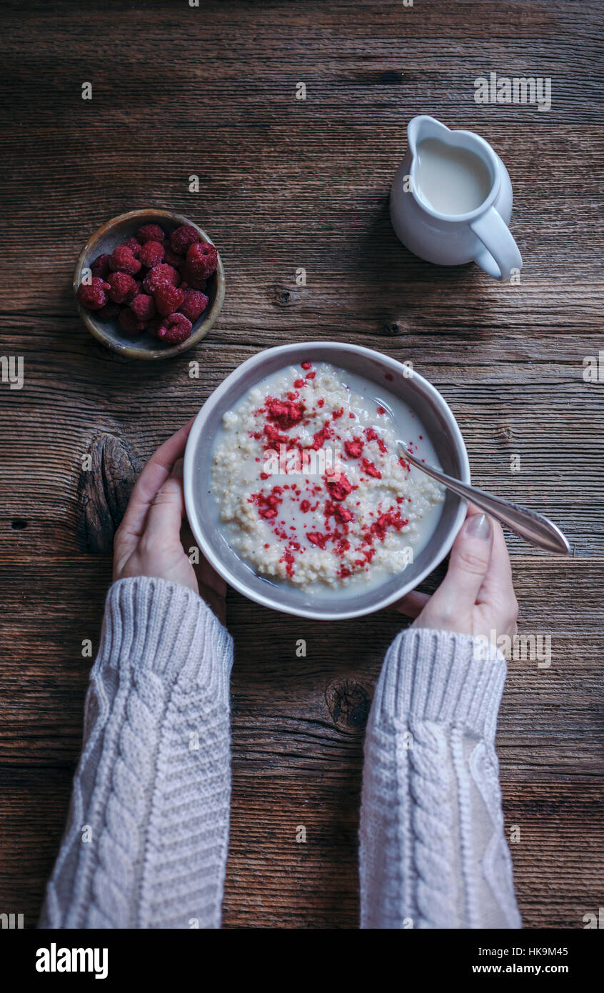 Woman eating millet porridge with raspberry powder Stock Photo - Alamy