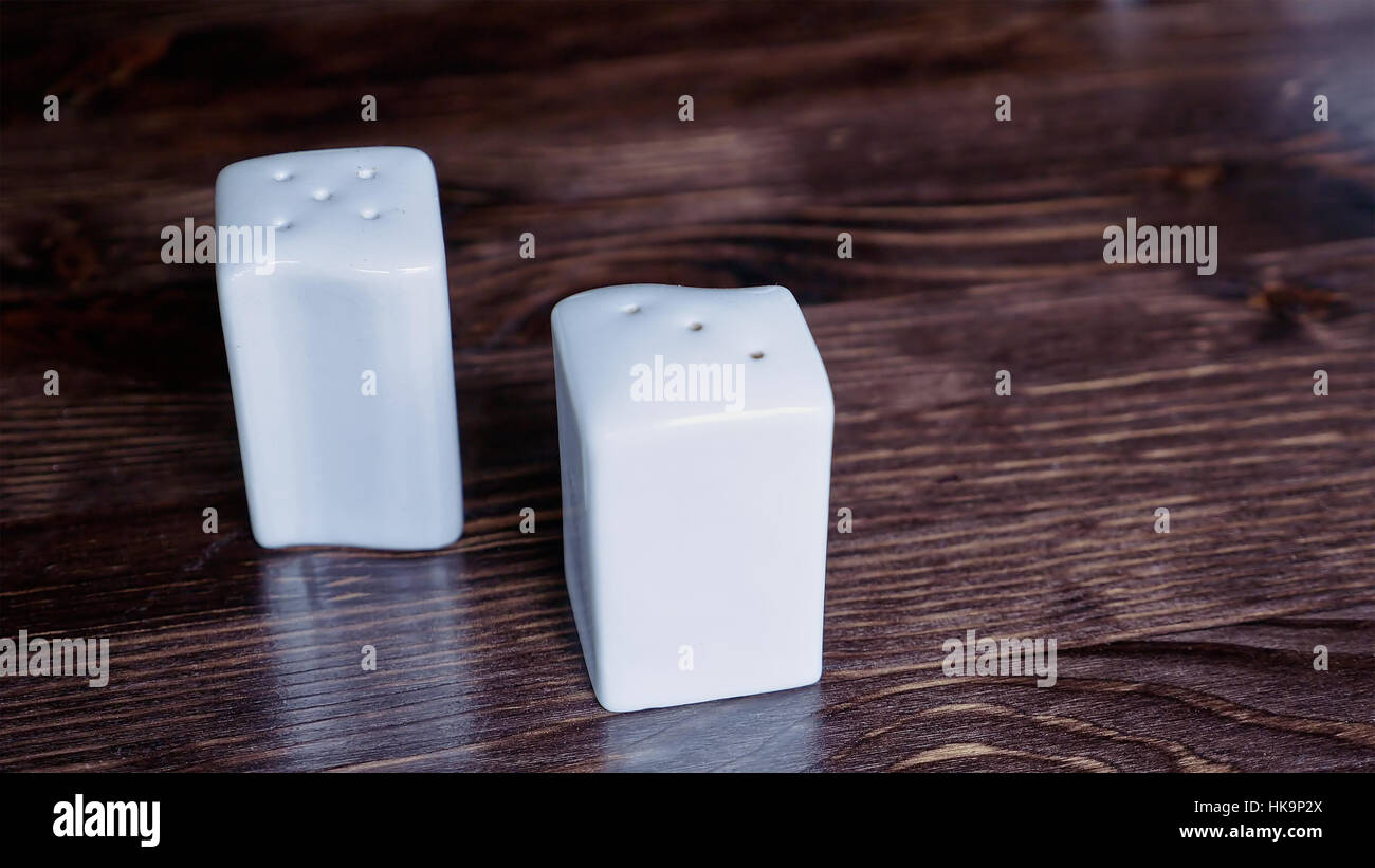 Pair of white salt and pepper pots Stock Photo - Alamy