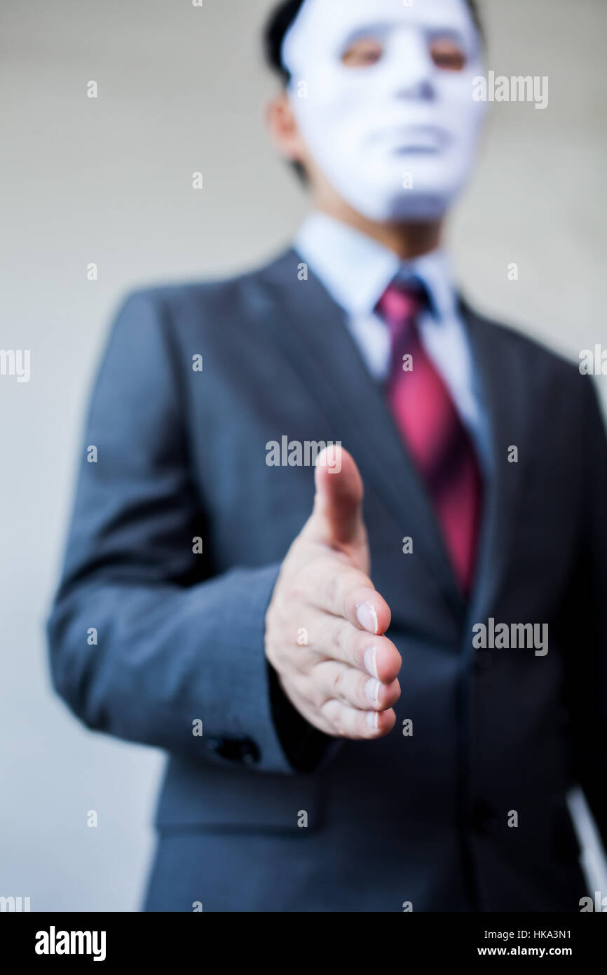 Business man giving dishonest handshake hiding in the mask - Business ...