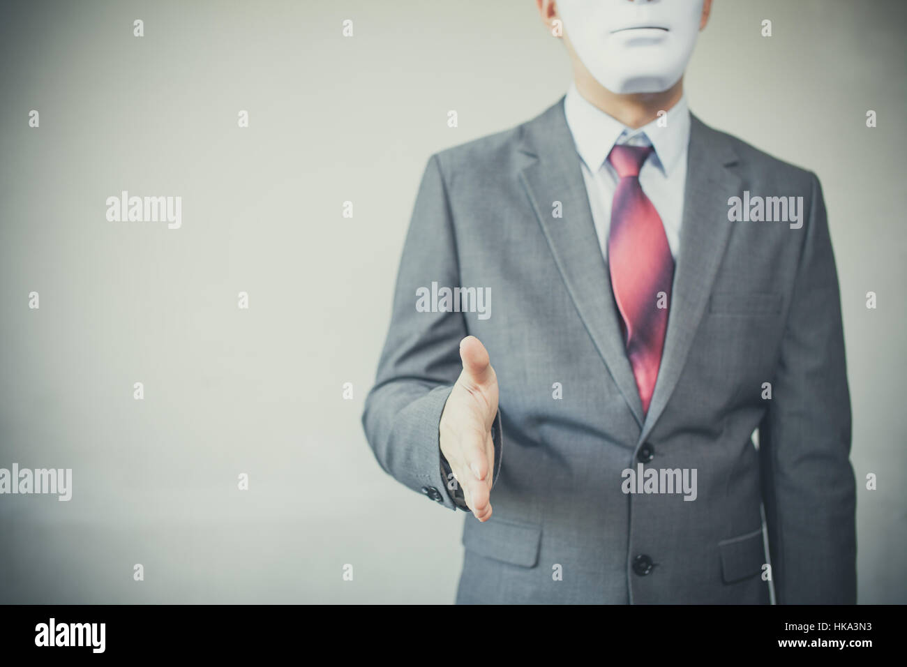 Business man giving dishonest handshake hiding in the mask - Business ...