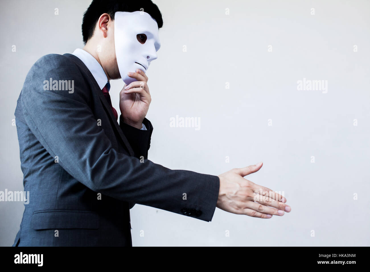 Business man giving dishonest handshake hiding in the mask - Business ...
