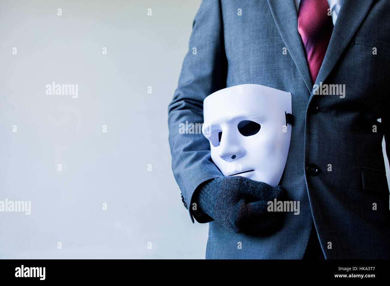 Business man carrying white mask to his body indicating Business fraud ...