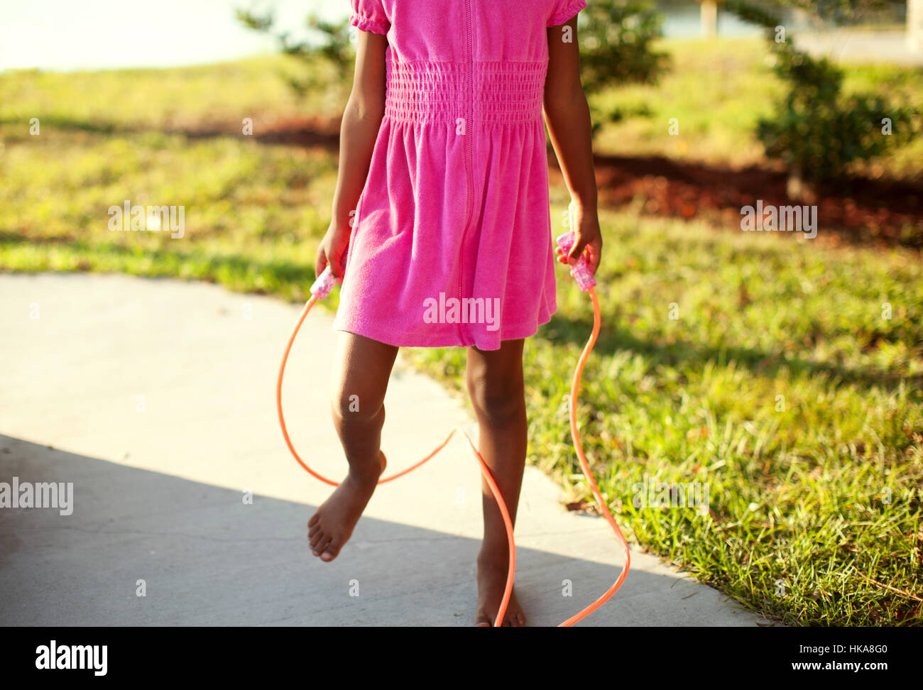 Little girl jumps rope Stock Photo - Alamy