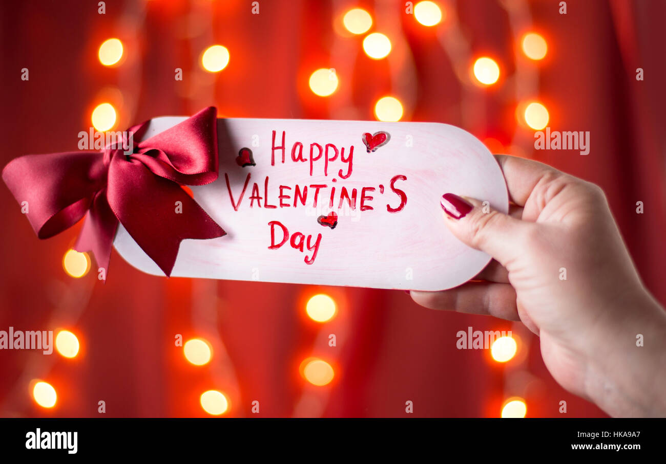Female hand holding Happy Valentines day card Stock Photo - Alamy