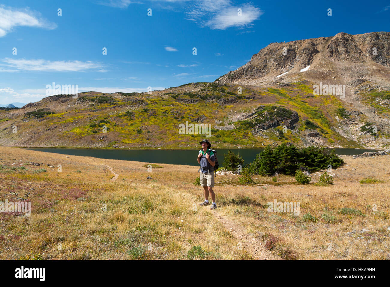 A hiker along the Beartooth Loop Trail in front of Gardner Lake in the ...