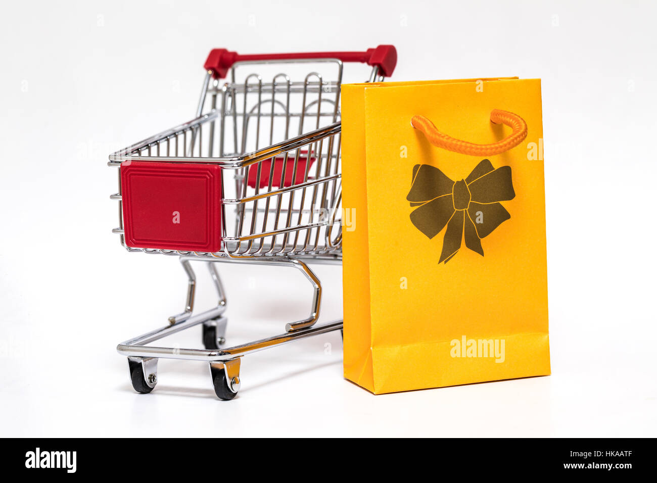 Shopping cart with cash receipt and shopping bag isolated on white ...