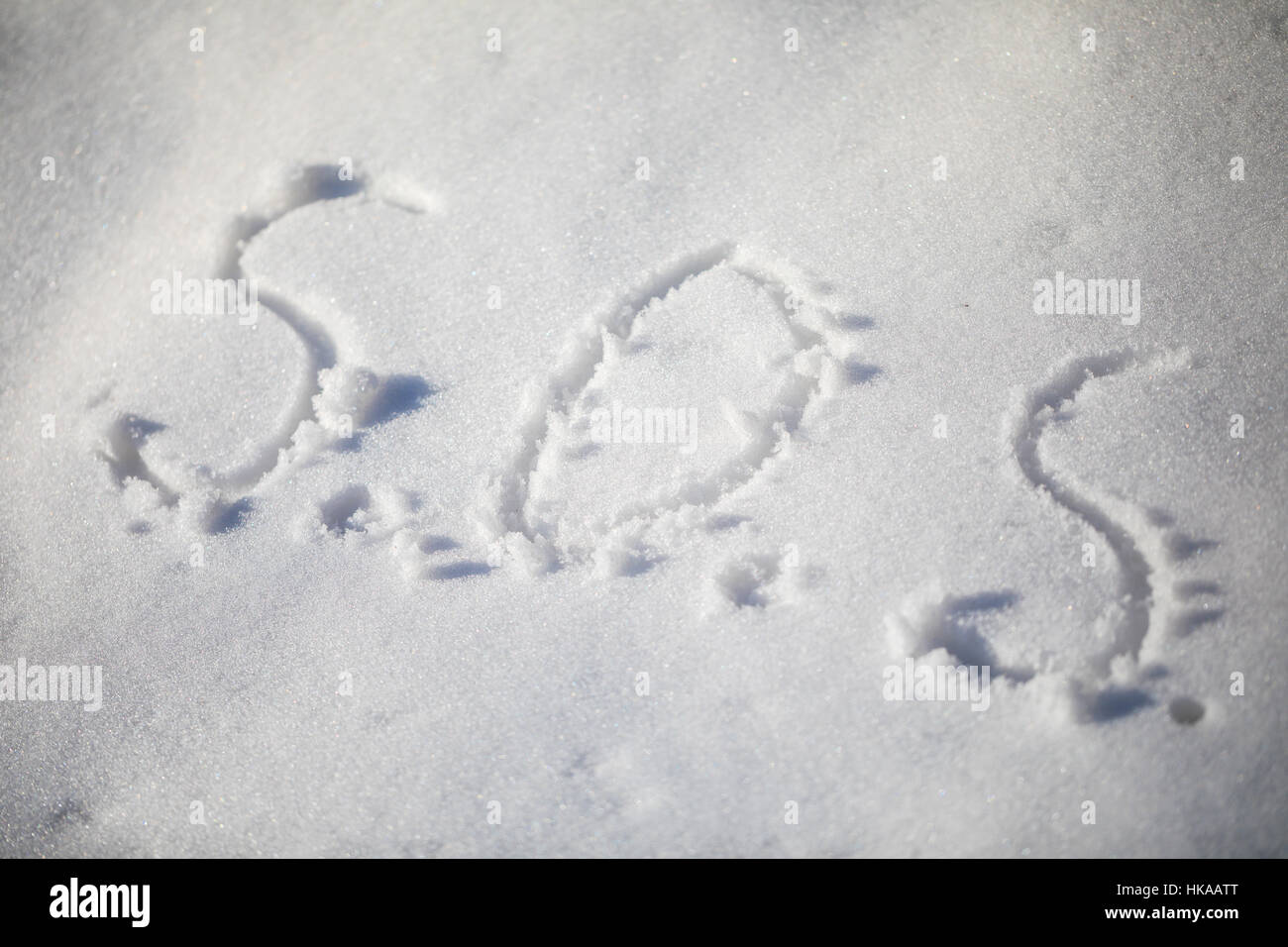 SOS sign for help needed written in the snow Stock Photo - Alamy