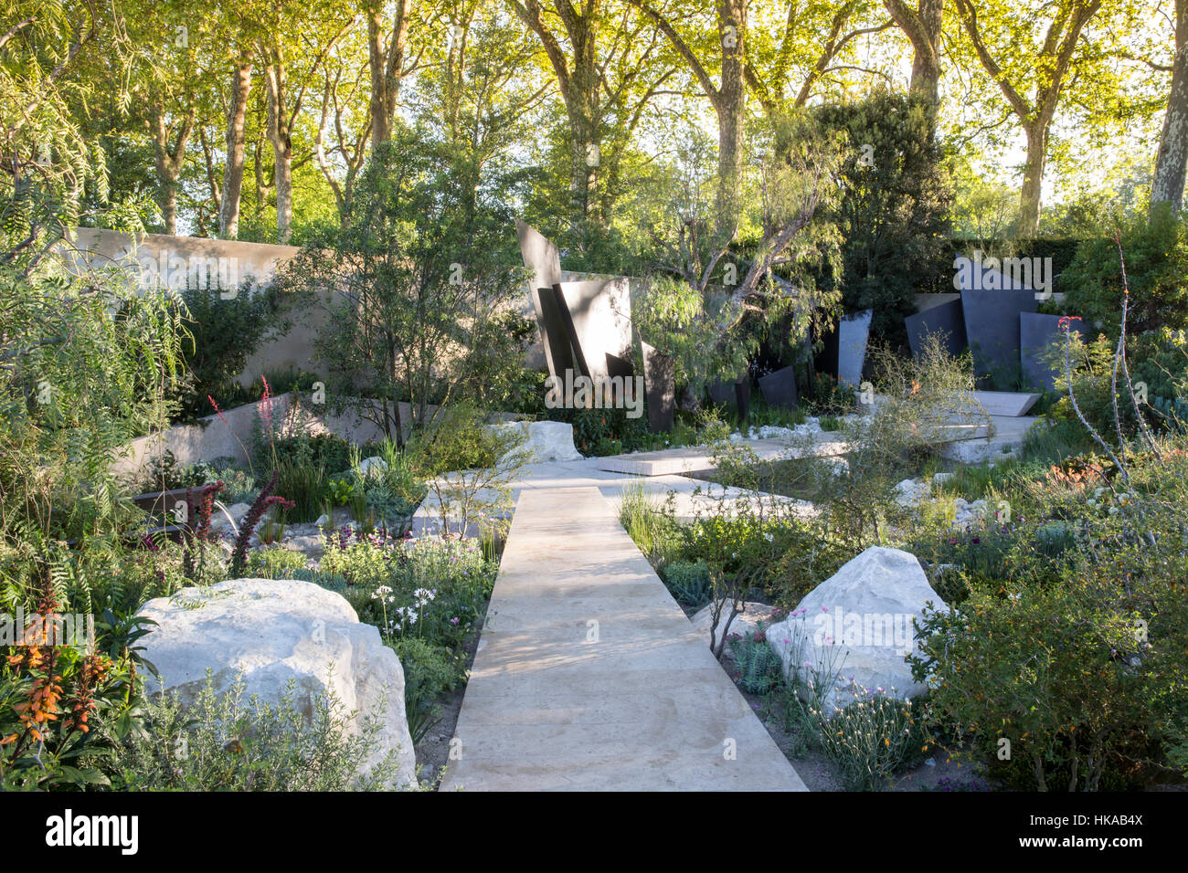 A contemporary modern garden path with metal screens leading to a ...