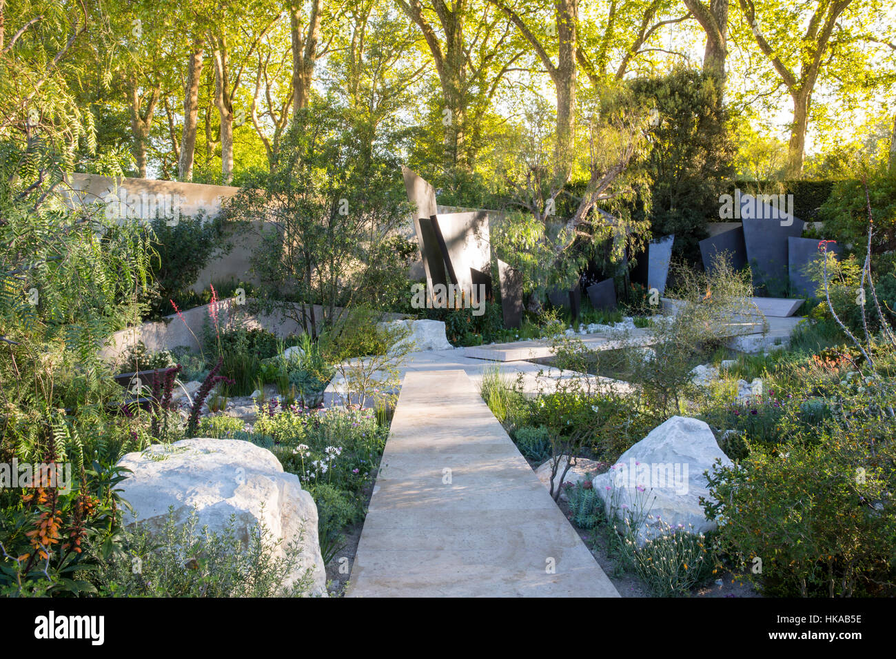 A contemporary modern garden path with metal screens leading to a ...