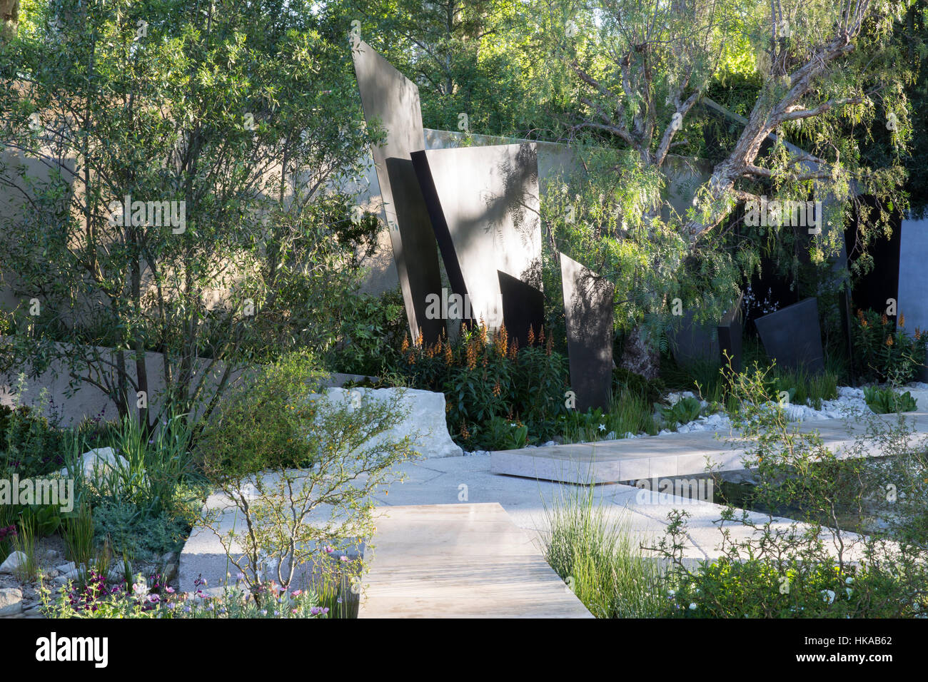 A contemporary modern garden path with metal screens leading to a ...