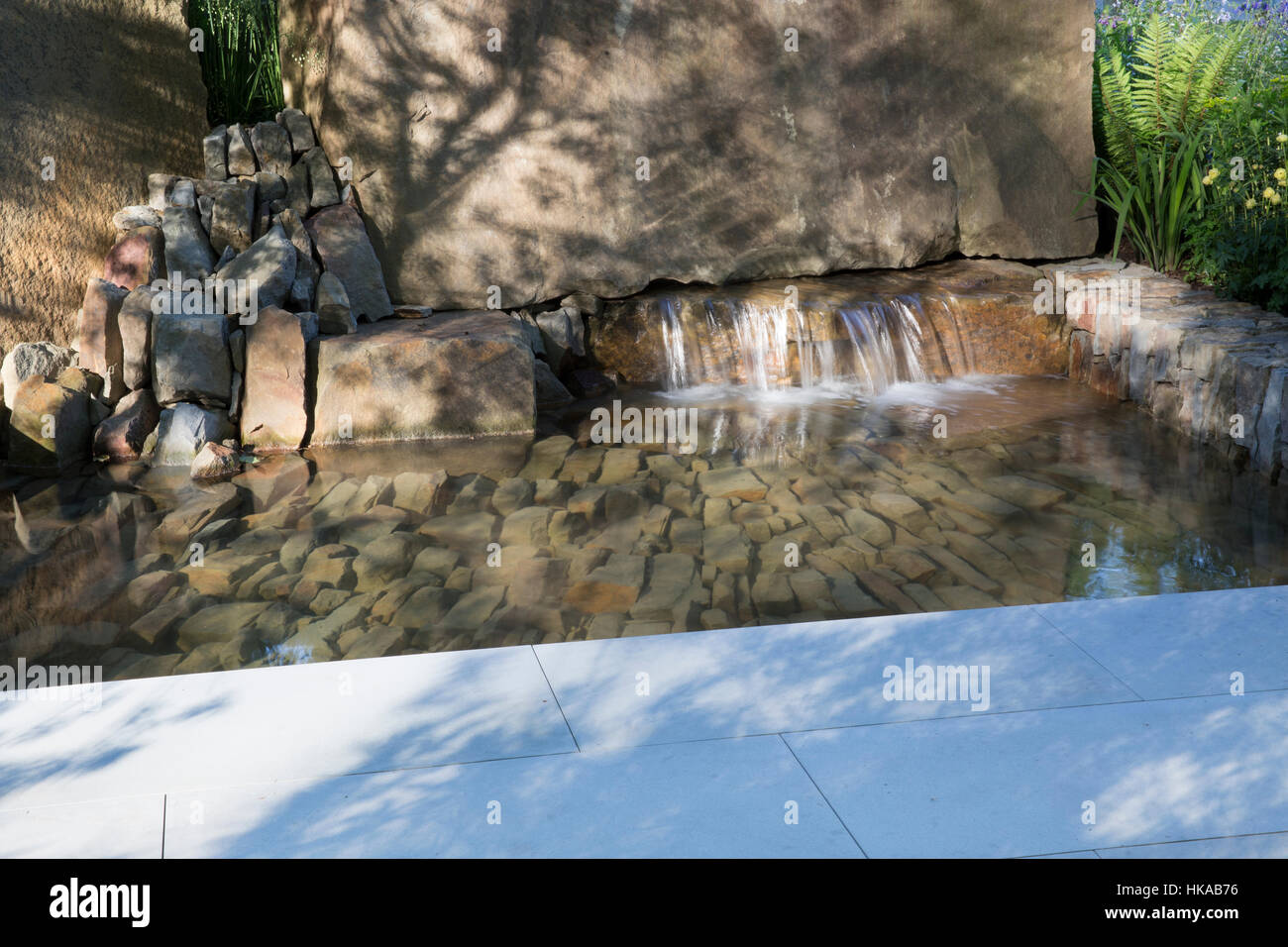 Modern contemporary garden with a small pond water feature water fall ...