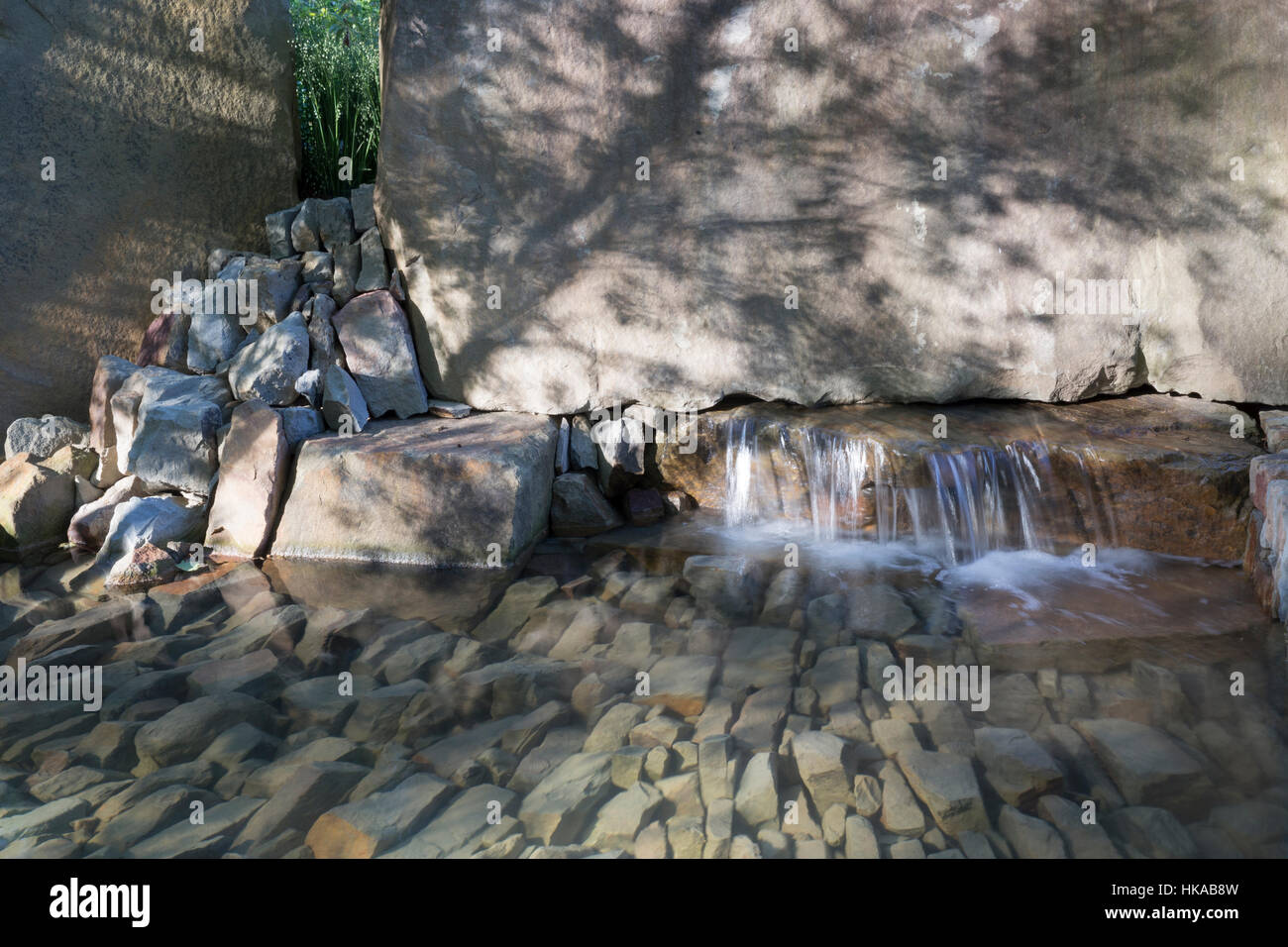 Modern contemporary garden with a small pond water feature water fall ...