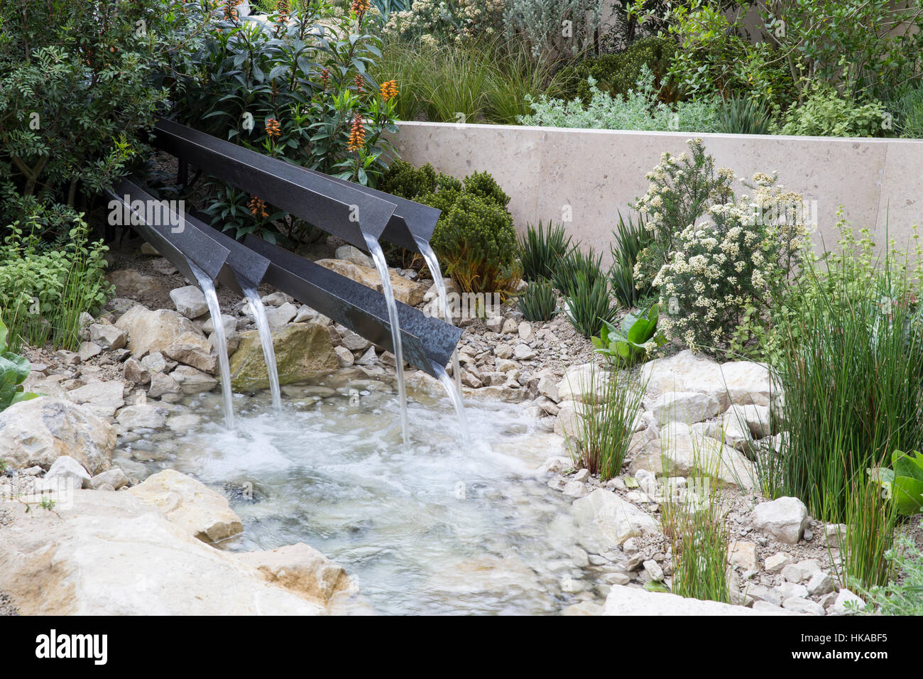 Modern contemporary garden with a small pond and rill water feature ...