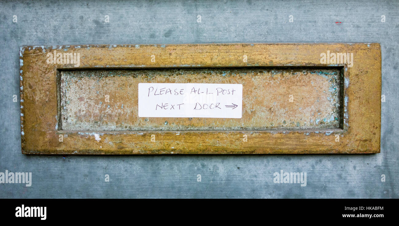 Leave post next door sticker on letterbox Stock Photo - Alamy