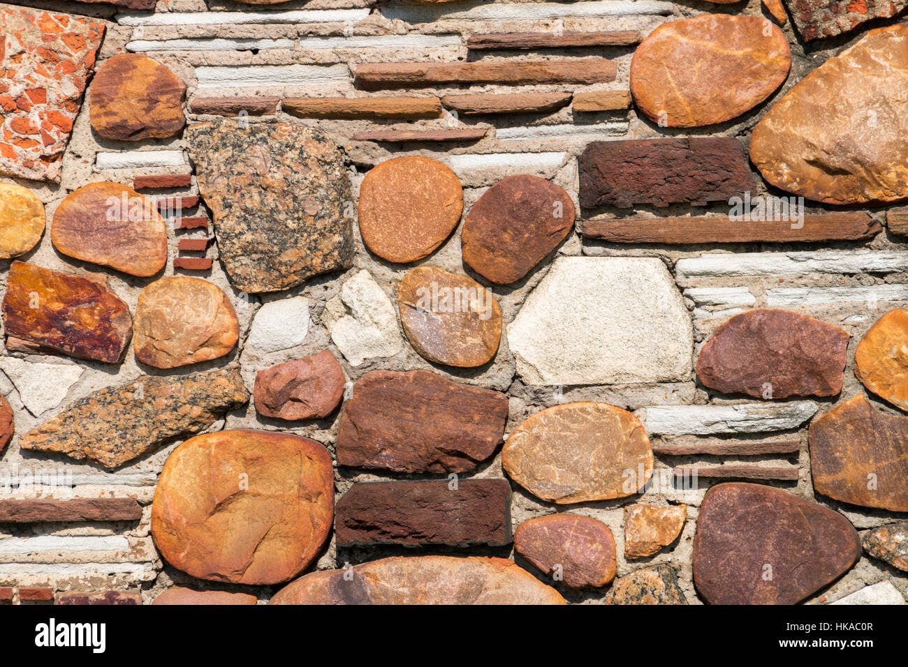 Close up of natural rocks and stone patterns and textures cemented on ...