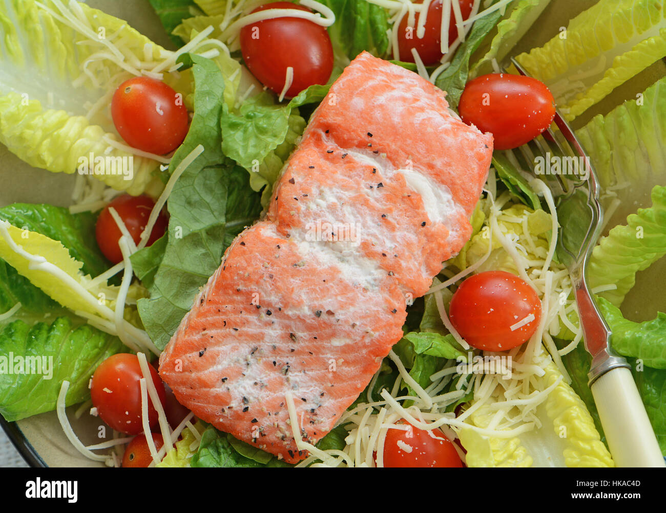 Cold cooked salmon filet with assorted salad ingredients for a healthy ...