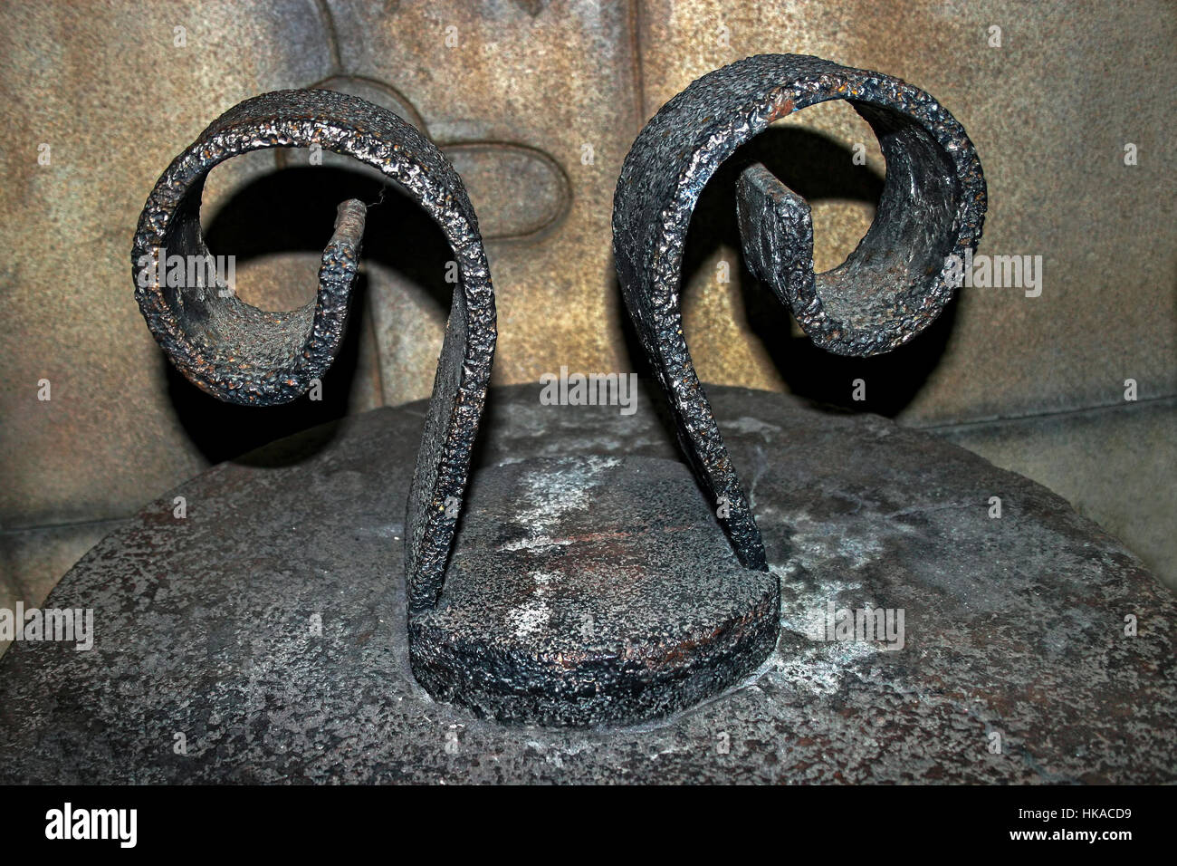 An old metal curved sculpture which is symmetrical Stock Photo - Alamy