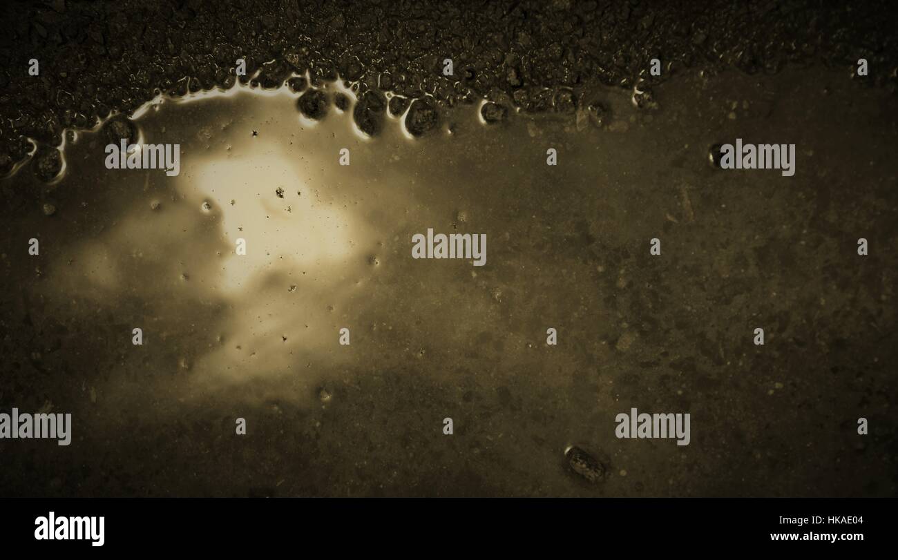 Rain puddle on concrete road Stock Photo - Alamy