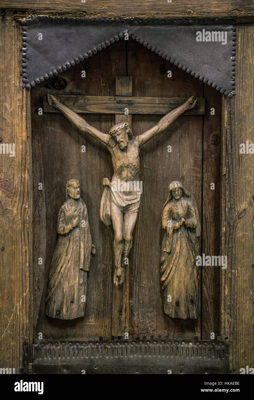 Crucifixion of Christ carved on ancient wooden icon. The wooden figure of the Crucifixion of ...