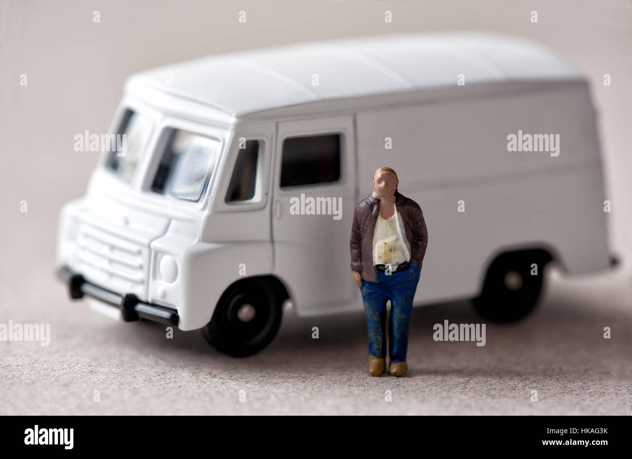 Miniature model driver standing next to his large white van Stock Photo ...