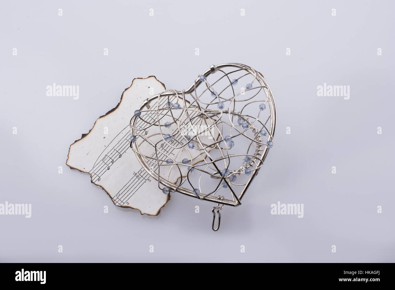 Musical notes on a burnt paper under a heart shape metal icon Stock ...