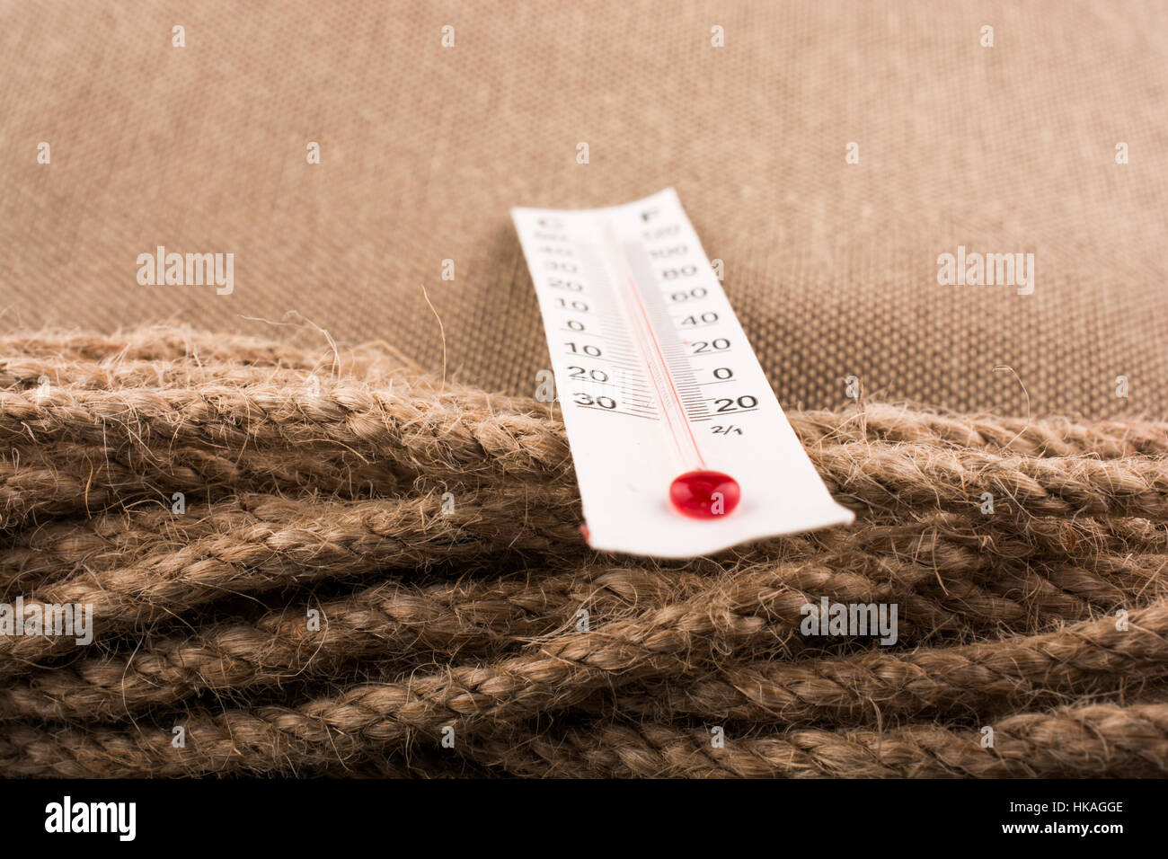 Thermometer placed on a brown rope on a fabric background Stock Photo ...