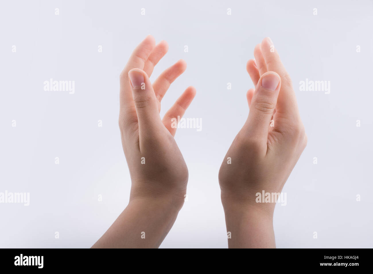 Hand holding gesture made on a white background Stock Photo - Alamy