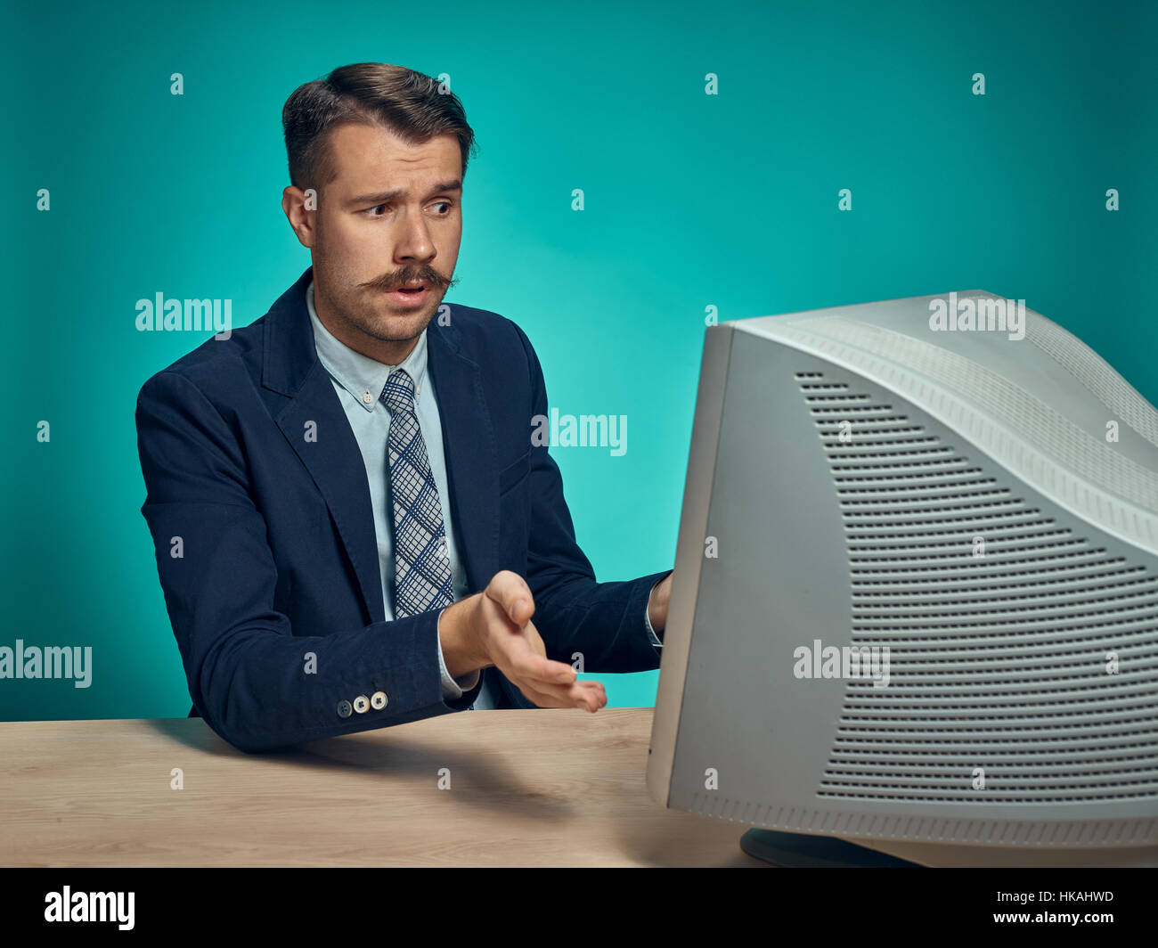 Sad Young Man Working On computer At Desk Stock Photo - Alamy