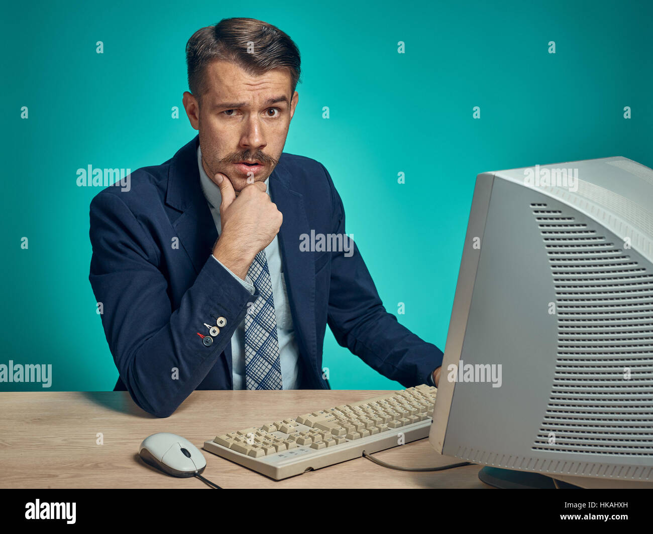 Sad Young Man Working On computer At Desk Stock Photo - Alamy