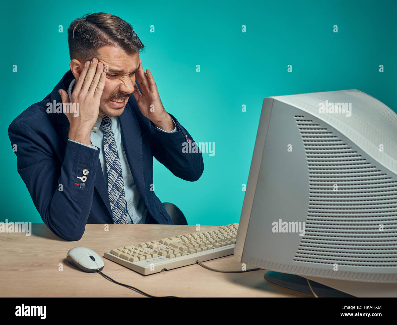 Sad Young Man Working On computer At Desk Stock Photo - Alamy