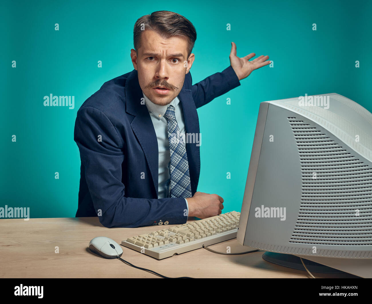Sad Young Man Working On computer At Desk Stock Photo - Alamy