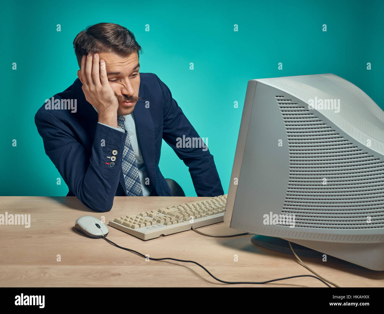 Sad Young Man Working On computer At Desk Stock Photo - Alamy