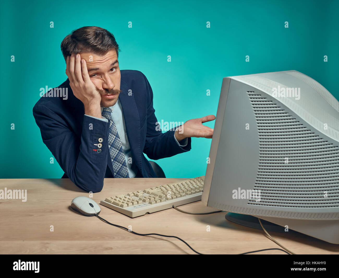 Sad Young Man Working On computer At Desk Stock Photo - Alamy