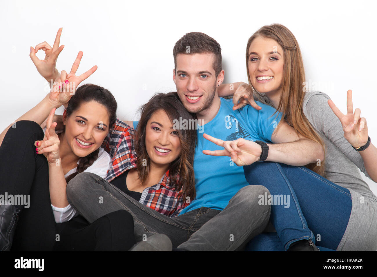 3 woman and 1 man showing victory sign with their hands Stock Photo - Alamy