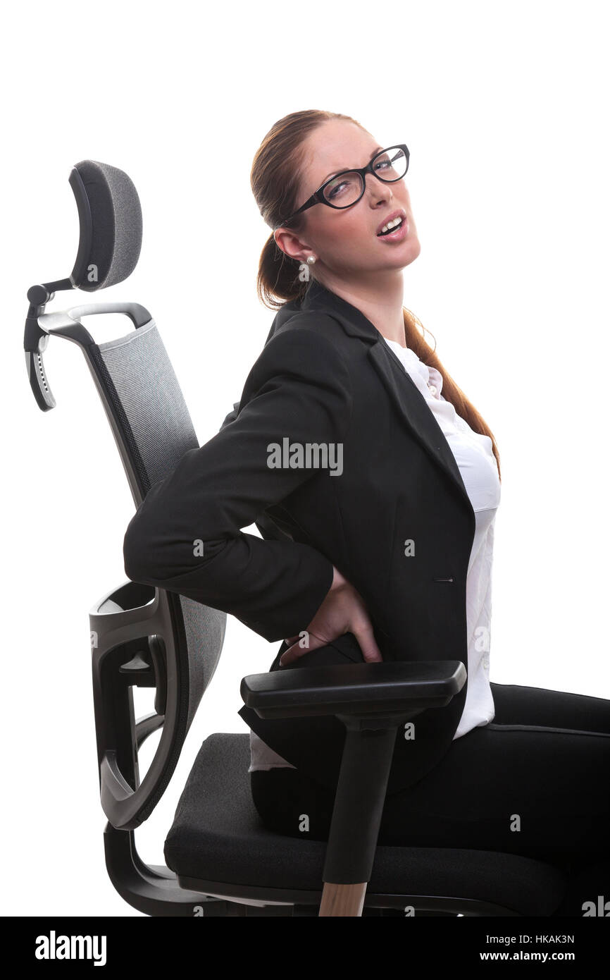 Woman sits on her office chair holding her back Stock Photo - Alamy