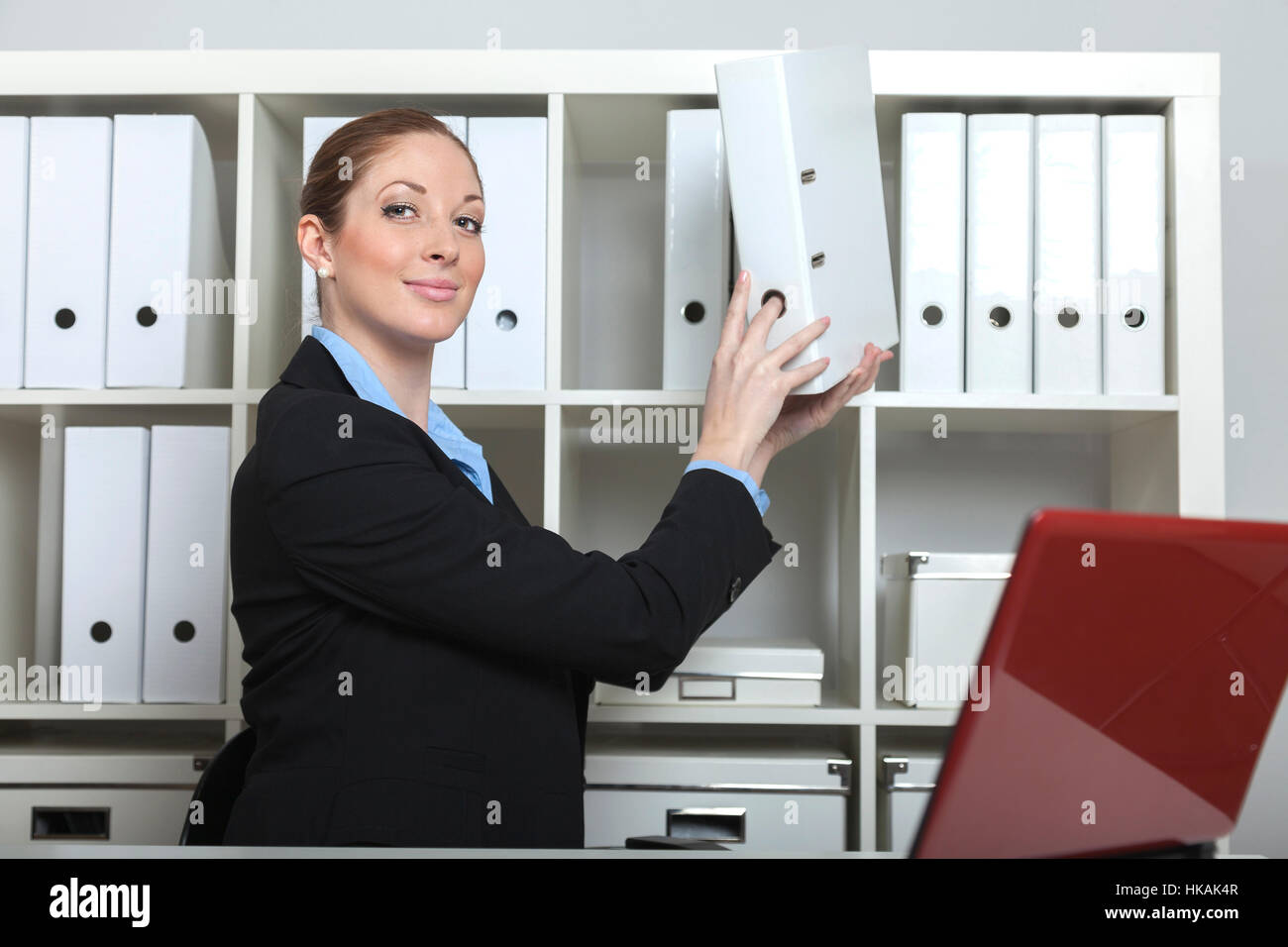 smart secretary puts a folder to the cabinet Stock Photo - Alamy