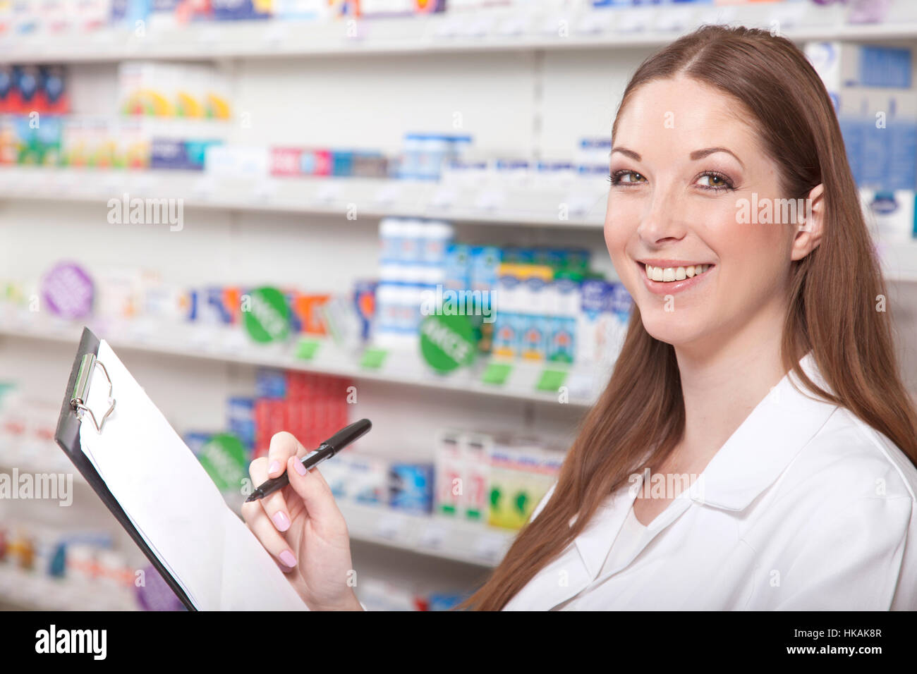 Pharmacist with clipboard while stocktaking in pharmacy Stock Photo - Alamy