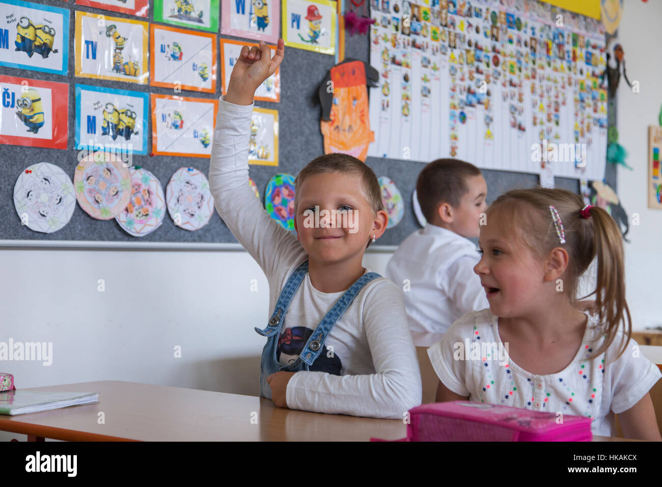 Schoolchildren in a classroom with one female nerd Stock Photo - Alamy
