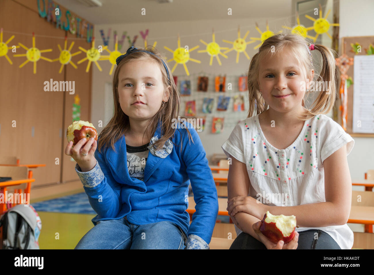 Primary school pupils eating apples in a classroom Stock Photo - Alamy