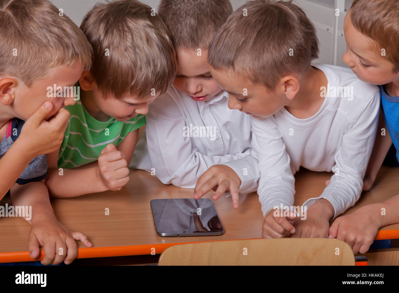School boys are watching a video on a tablet pc Stock Photo - Alamy