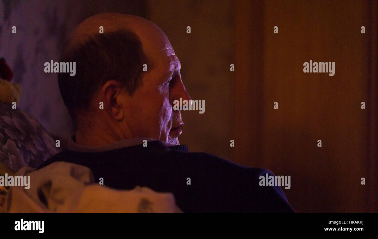 Man watching TV and talking close-up Stock Photo - Alamy