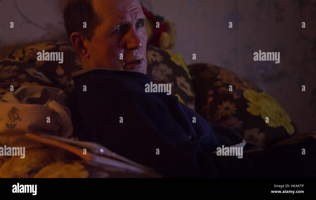 Man watching TV and talking close-up Stock Photo - Alamy