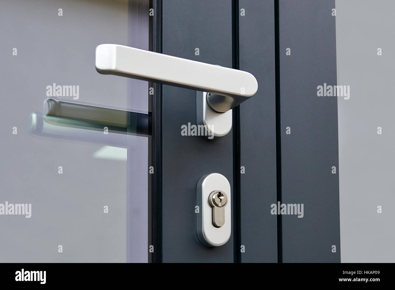 Exterior door handle and Security lock on Metal frame Stock Photo - Alamy