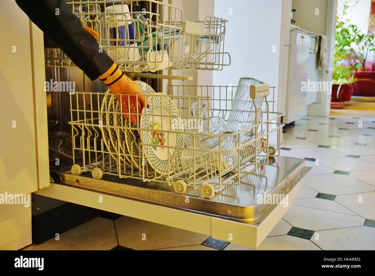 Unloading the dishwasher Stock Photo - Alamy