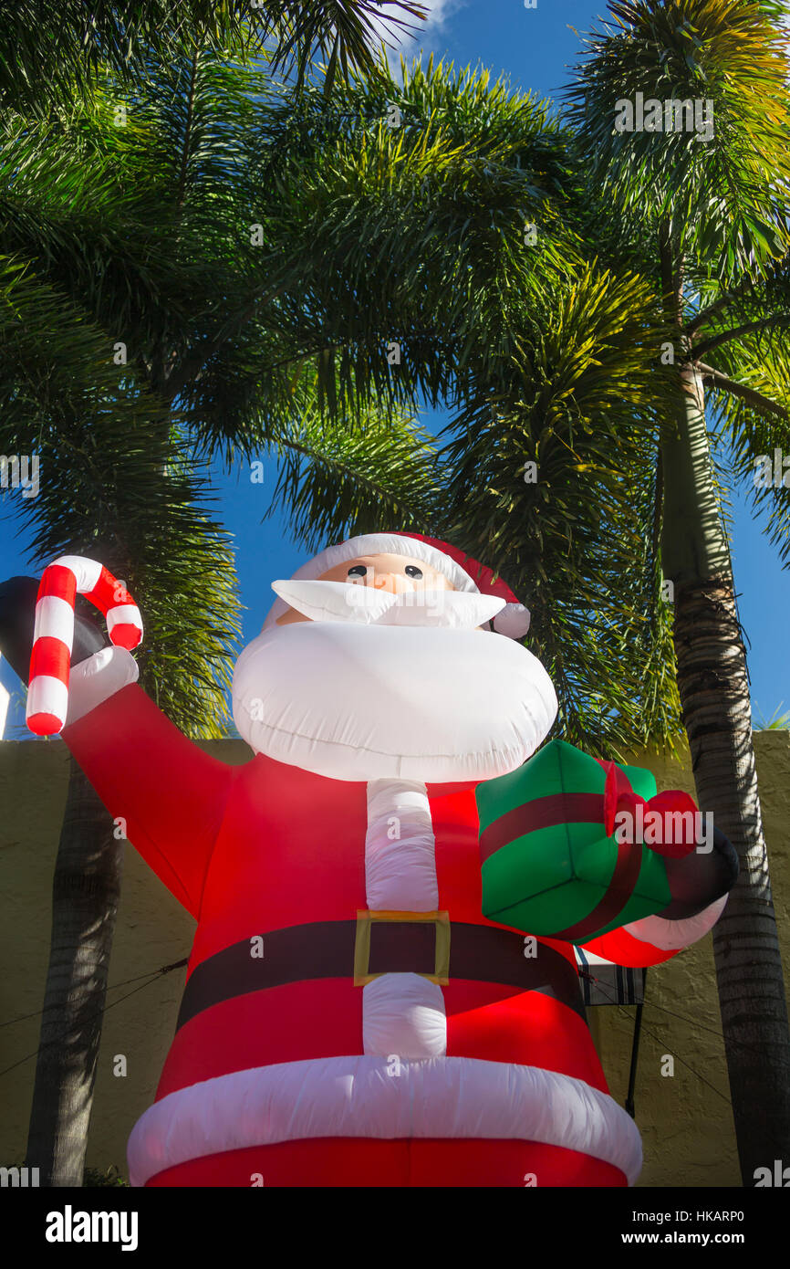 GIANT INFLATABLE SANTA CLAUS IN FRONT OF PALM TREES IN RESIDENTIAL ...