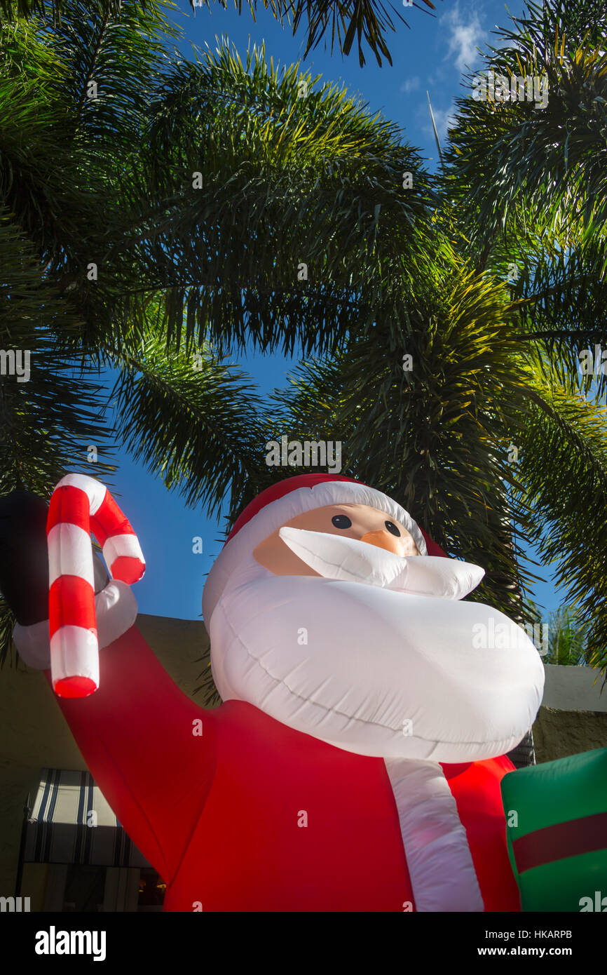 GIANT INFLATABLE SANTA CLAUS IN FRONT OF PALM TREES IN RESIDENTIAL ...