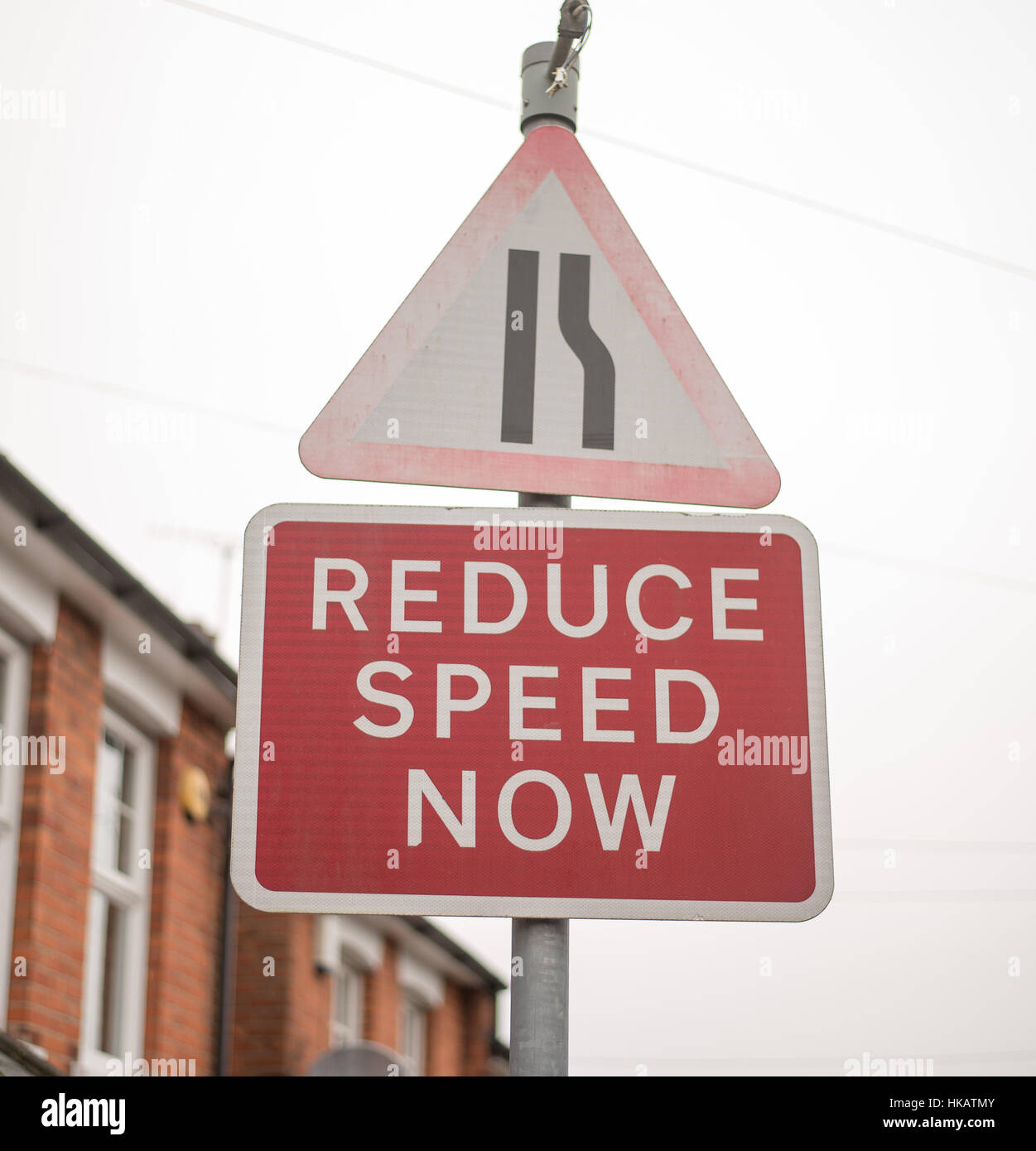 Reduce speed sign; UK urban road sign Stock Photo - Alamy