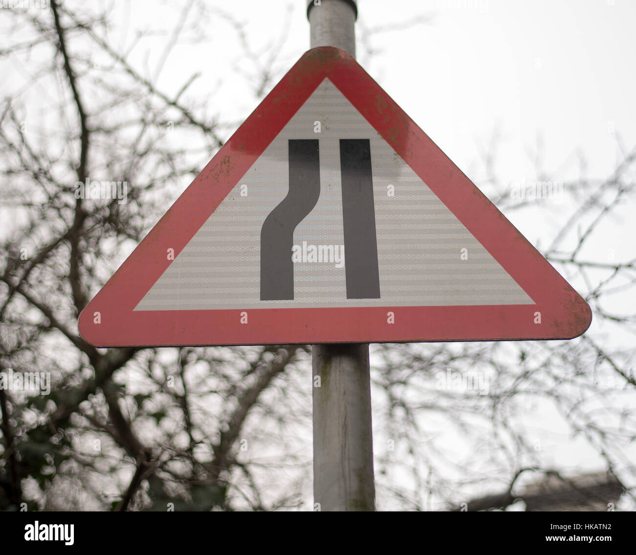Road narrows from left, UK urban road sign Stock Photo - Alamy
