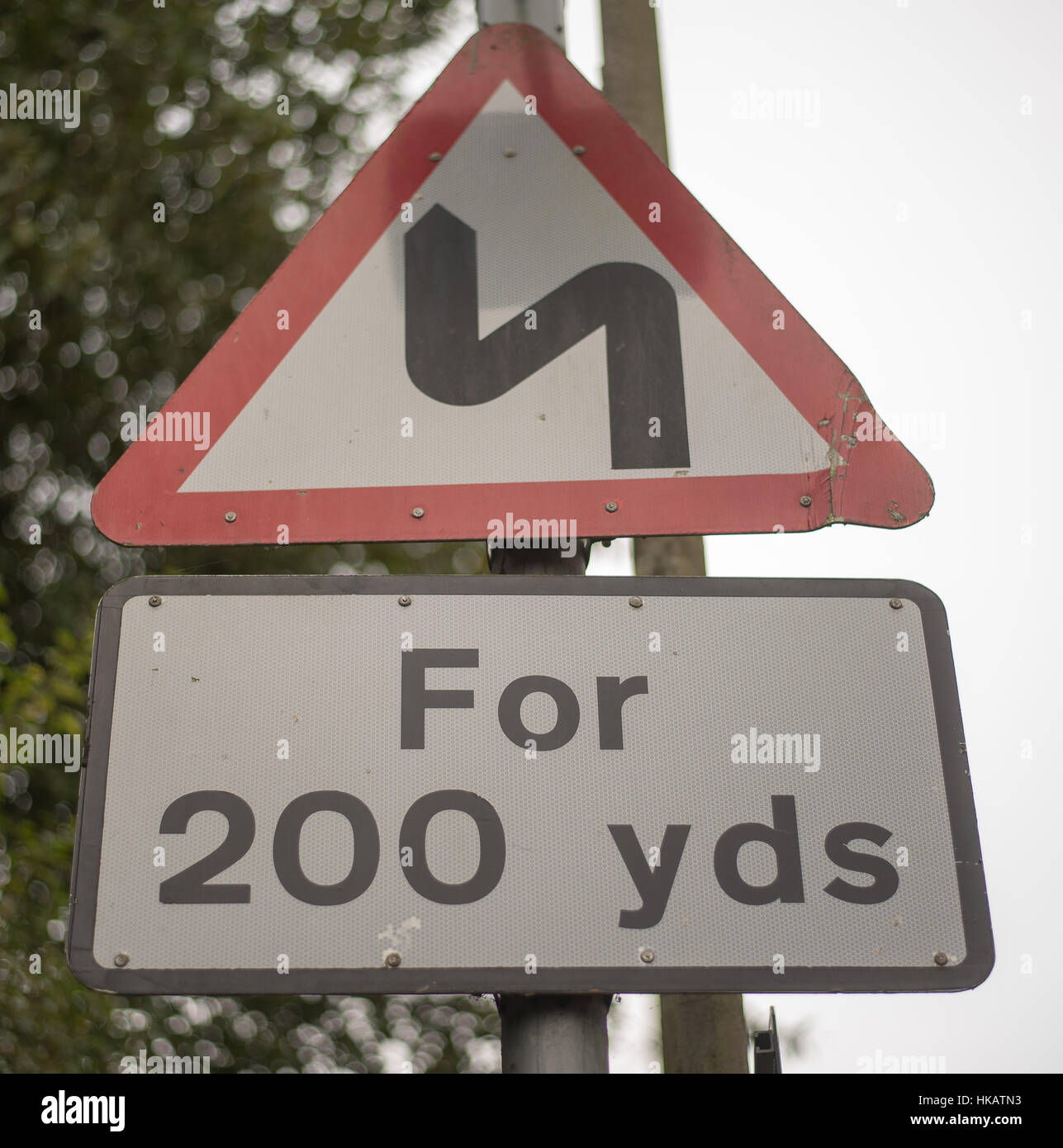 Bends in road, UK urban road sign Stock Photo - Alamy